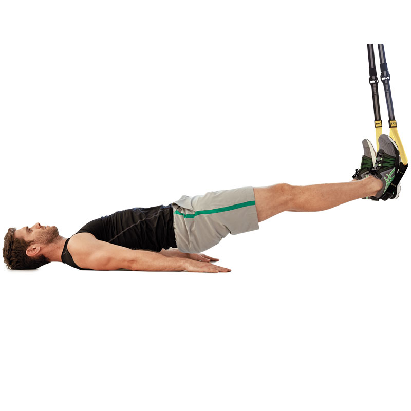 TRX Hamstring Curl Exercise Video Guide | Muscle & Fitness